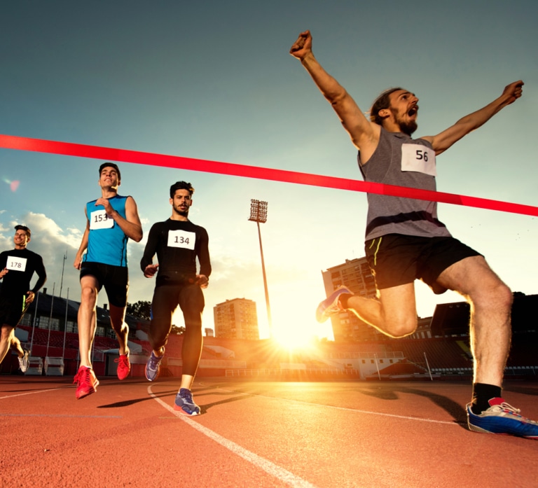 Successful athlete crossing the finish line and winning the race ...